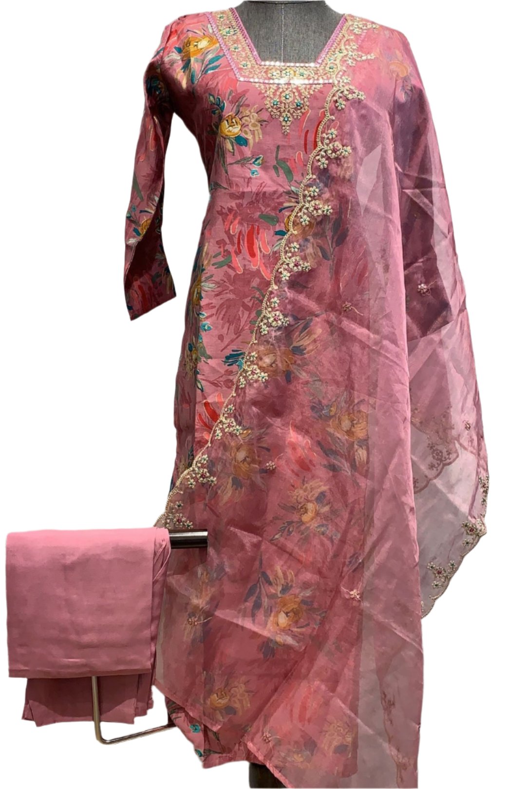 South Asian dress adorned with intricate gold embroidery. The floral p ...